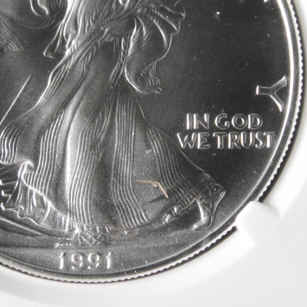 1991 $1 American Silver Eagle NGC MS69 Mint Error Obverse Struck Thru Brown Label - Pinehurst Coins